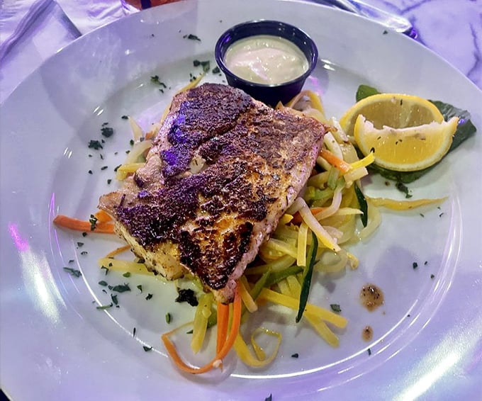 Blackened grouper resting on a bed of julienned vegetables—proof that healthy eating and indulgence aren't mutually exclusive concepts after all.