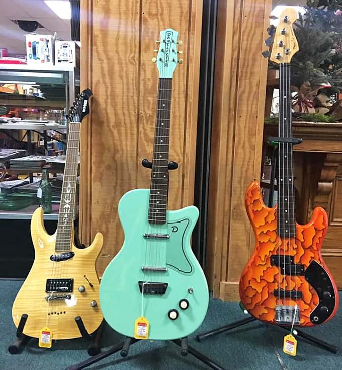 Electric guitars in candy colors stand at attention, silently holding the potential for both garage band dreams and neighbor complaints.