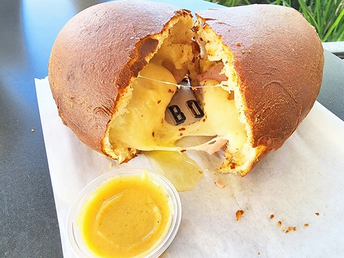 Behold the ham and cheese bomb – a golden-baked miracle with molten center that makes the sandwich world question its very existence.