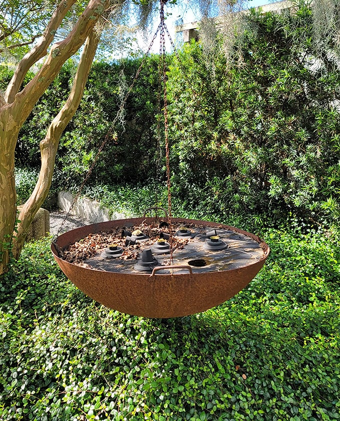 This hanging copper bowl isn't your average birdbath—it's avian fine dining. Birds probably tell their friends, "Meet me at that fancy copper place with the great ambiance."