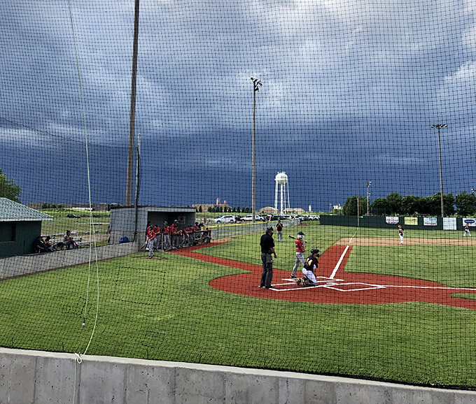 America's pastime thrives in Harrisburg, where community baseball brings generations together under dramatic South Dakota skies that upstage even the most impressive home runs.