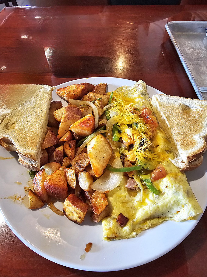 An omelet that's having a party and invited all your favorite breakfast ingredients, with perfectly seasoned home fries as the plus-one.