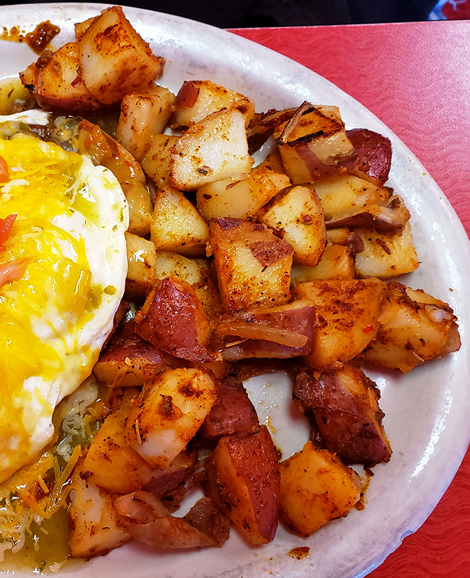 These aren't just home fries—they're potato cubes that have achieved crispy-edge nirvana while maintaining their tender, steamy souls.