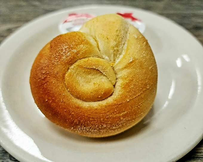 A homemade roll that doesn't need butter but deserves it anyway &ndash; pillowy perfection on a plate.