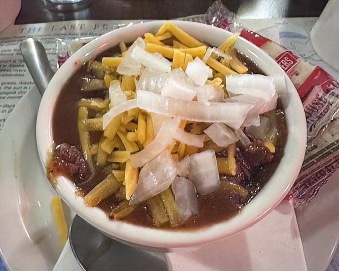 A bowl of chili topped with cheese and onions&mdash;winter warmth in edible form, perfect for those endless Alaskan nights.