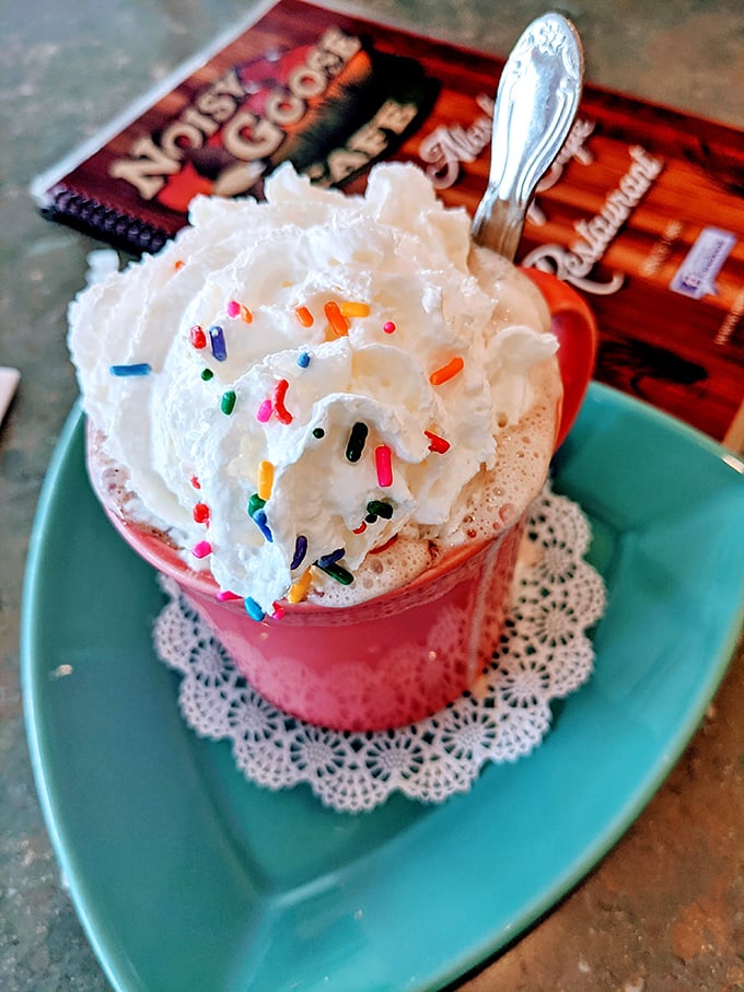 This hot cocoa doesn't just arrive &ndash; it makes an entrance, crowned with whipped cream and rainbow sprinkles that would make your inner child high-five your adult self.
