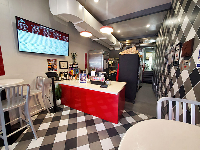 The clean lines and pop of red against the checkerboard floor create a diner atmosphere that's both modern and nostalgic.