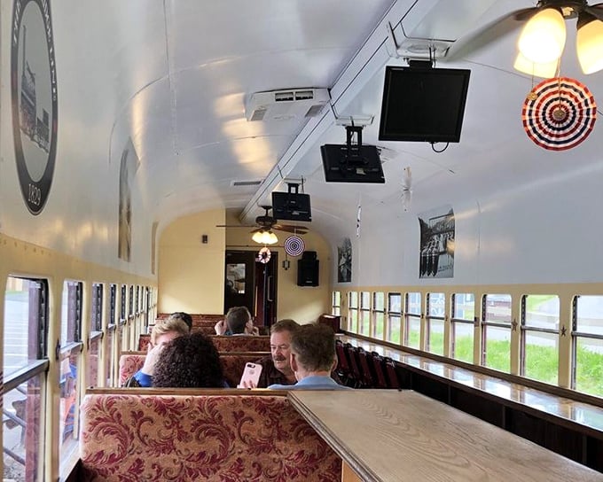 Plush burgundy seating and historical photos transform this coach into a rolling museum where comfort meets education&mdash;the best kind of classroom.