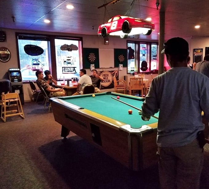 The pool table area offers entertainment between bites, though the real sport is watching newcomers fall in love with their first taste.