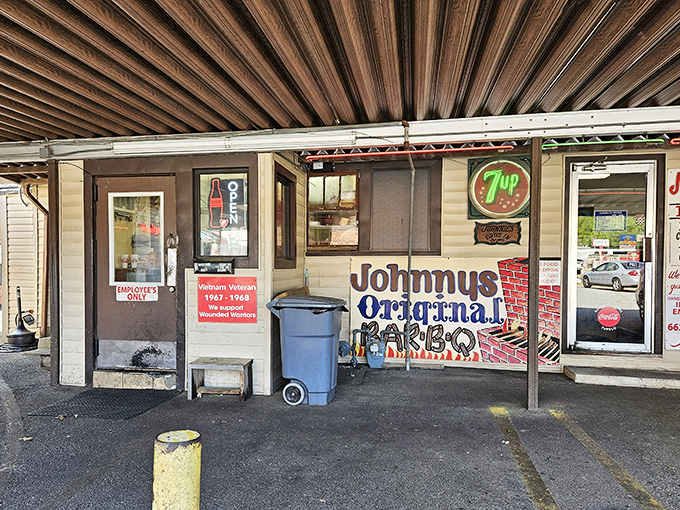 Johnny's Drive-In serves up nostalgia with a side of legendary barbecue. Those hand-painted signs promise authentic flavor that corporate chains can only dream about.
