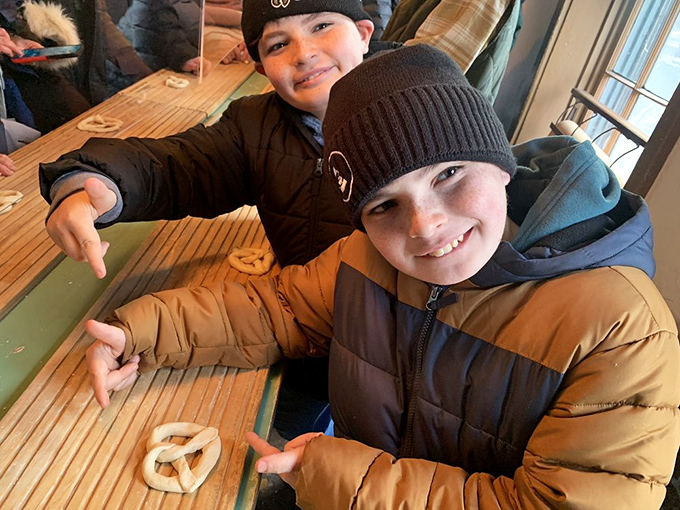 Future pretzel artisans at work! These young visitors are learning the ancient art of dough-twisting with impressive concentration.