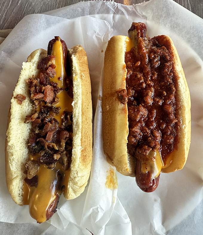 Two hot dogs living their best lives&mdash;one smothered in chili, the other playing matchmaker between cheese and savory toppings.