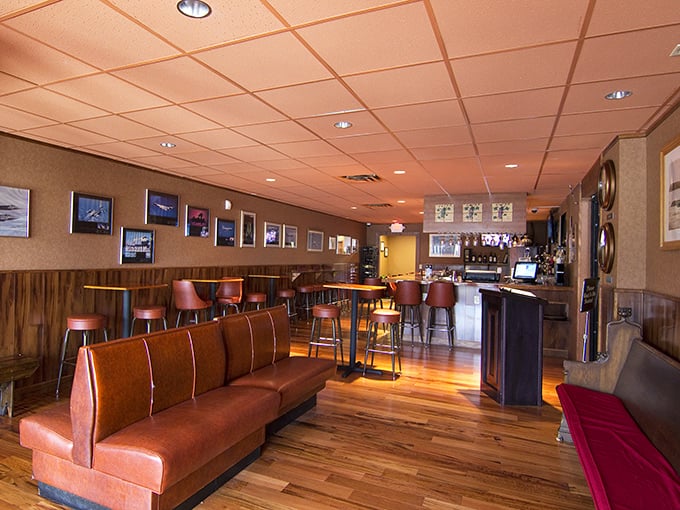 The lounge area offers a warm retreat with its wooden accents and leather seating—the perfect spot to sip a glass of Chianti while waiting for your table.