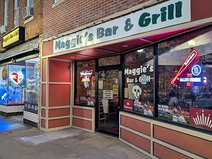Maggie's Bar & Grill glows with neon promise as evening falls. Those illuminated signs aren't just decoration—they're beacons calling you to good times.
