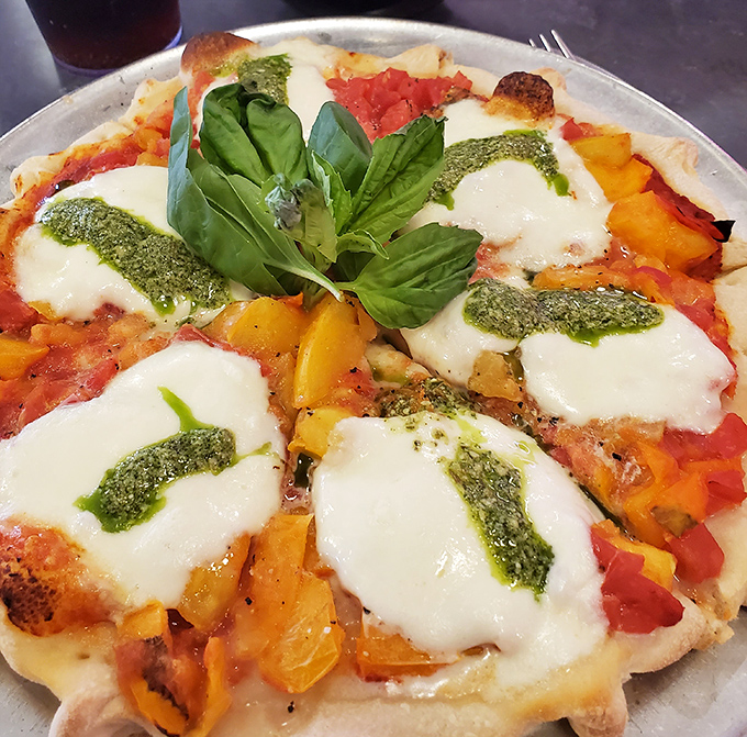 Pizza that honors its Italian roots while embracing Santa Fe spirit&mdash;fresh basil and pesto drizzles elevate this from meal to masterpiece.