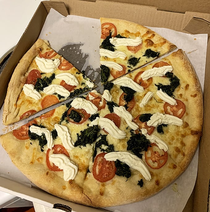 White pizza with fresh tomatoes, spinach, and dollops of ricotta&mdash;like a garden party where cheese is the guest of honor.