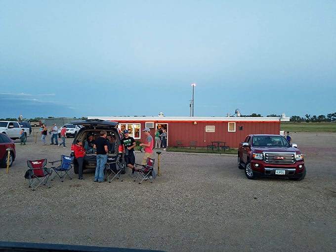 The Midway Drive-In, where summer evenings transform into social gatherings under South Dakota's expansive twilight sky.