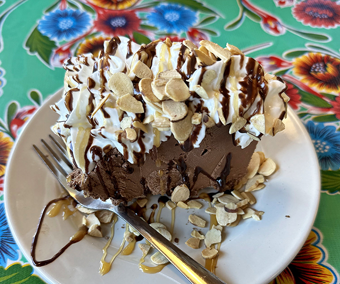 Chocolate mud pie topped with whipped cream and nuts. This isn't dessert&mdash;it's therapy that happens to taste like chocolate heaven.