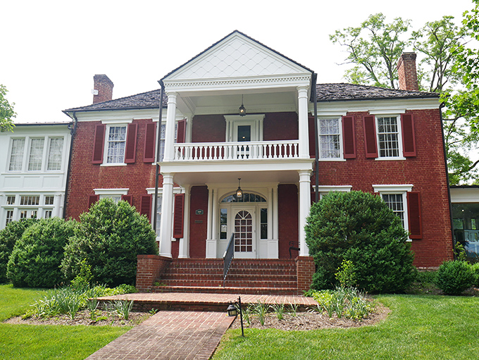 The General Lewis Inn combines colonial charm with Southern hospitality, its red brick exterior promising comfort with a side of history.