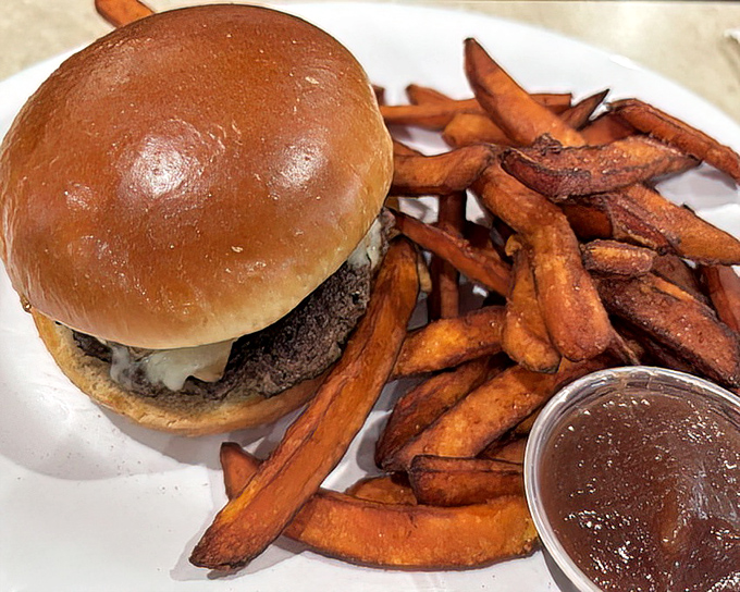 This burger doesn't just satisfy hunger&mdash;it obliterates it. Those sweet potato fries look like they're auditioning for a food magazine cover shoot.