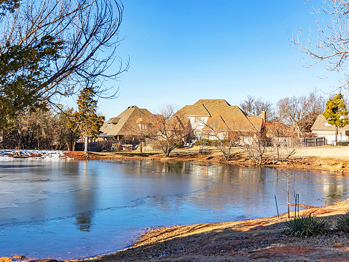 Winter transforms Oak Tree Park into a serene postcard scene. The frozen pond reflects nearby homes like nature's own Instagram filter.