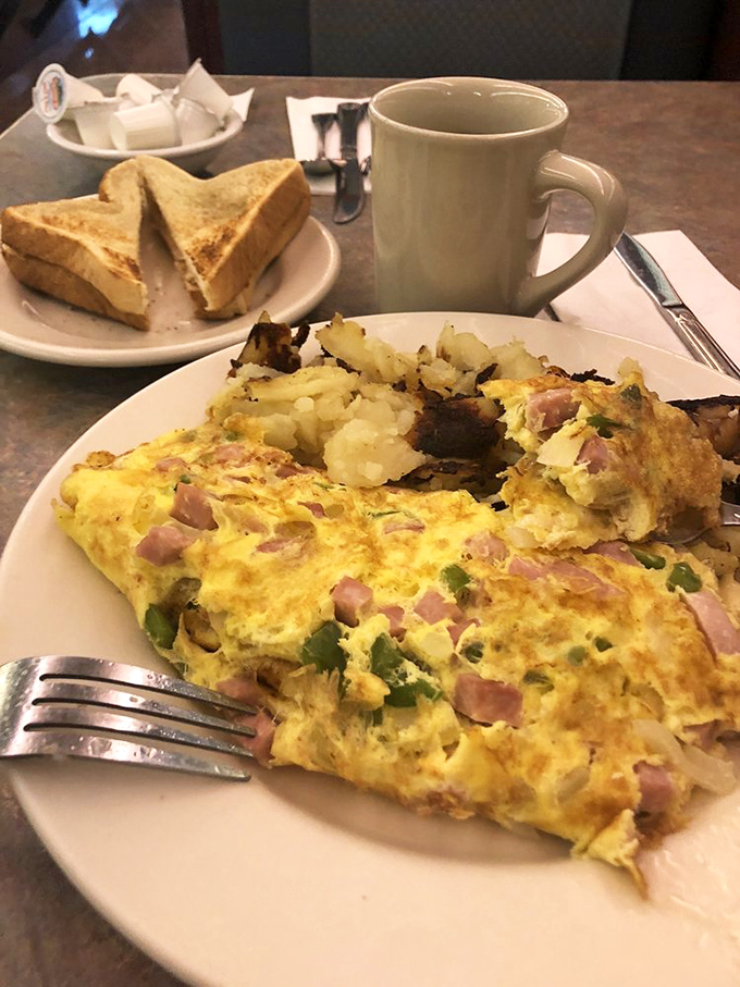 This Western omelet, fluffy and stuffed with ham and peppers, proves breakfast is the most important art form of the day.