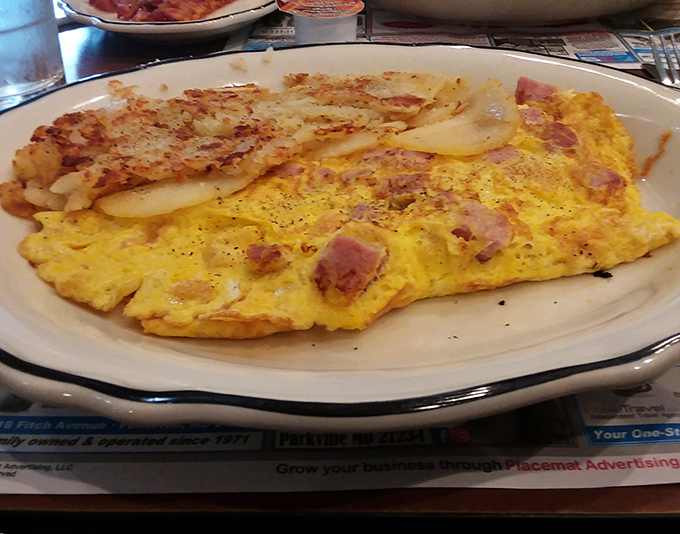 The Western omelet &ndash; where eggs, ham, and vegetables perform a perfect breakfast ballet, accompanied by home fries that deserve their own standing ovation.