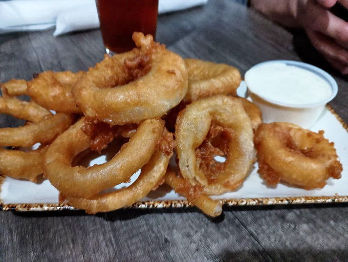 Onion rings that achieve the perfect golden ratio &ndash; crispy enough to crackle, tender enough inside to remind you why simple pleasures often taste the best.