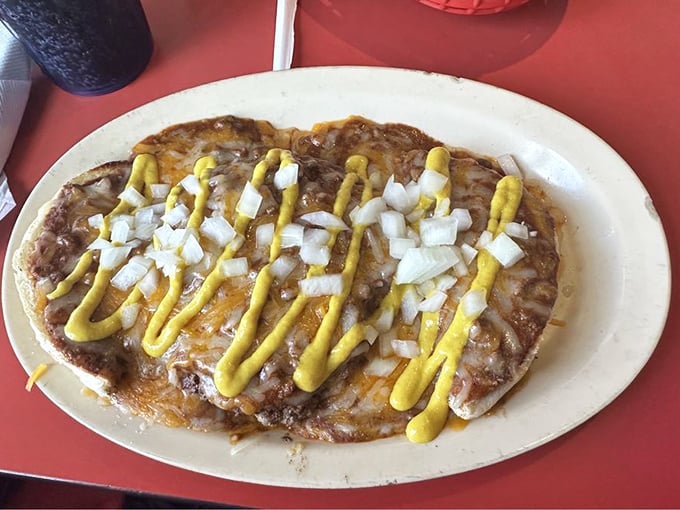 When chili meets burger meets cheese, magic happens. Those mustard stripes aren't decoration; they're essential flavor highways.