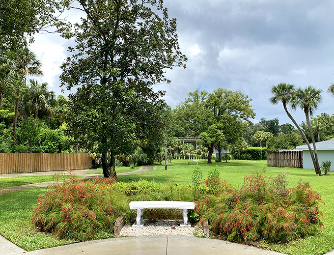 A quiet moment awaits on this garden bench surrounded by Florida's natural beauty. Sometimes the best vacation memories happen in these unscheduled pauses.
