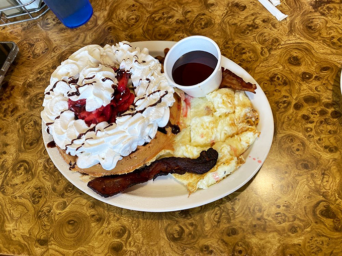 A pancake so fluffy it could double as a pillow, topped with enough whipped cream to make a cloud jealous. Sweet dreams are made of this.