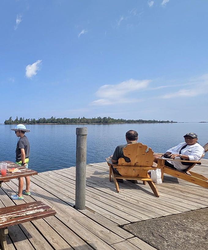 Lake Superior's version of a living room—wooden chairs on a sun-dappled dock where time slows to match the gentle lapping of waves against weathered planks.