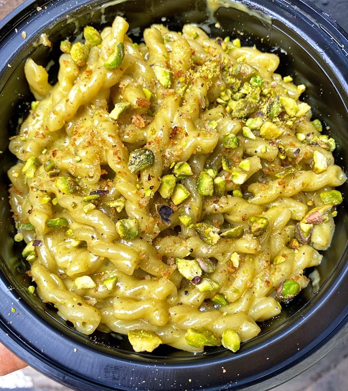 Pistachio pasta that looks like it's auditioning for a starring role in your food dreams. Creamy, nutty perfection in a humble takeout container.