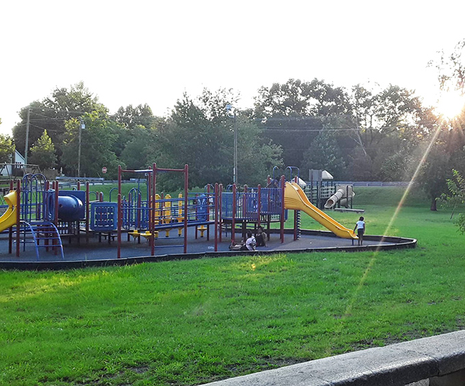 Sunset casts a golden glow over this playground paradise. Remember when your biggest worry was who got the good swing? Those days are still available here.