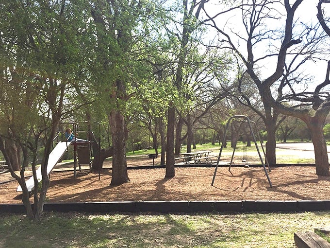 The playground nestled among native trees offers kids the original version of screen time &ndash; watching shadows dance through leaves.