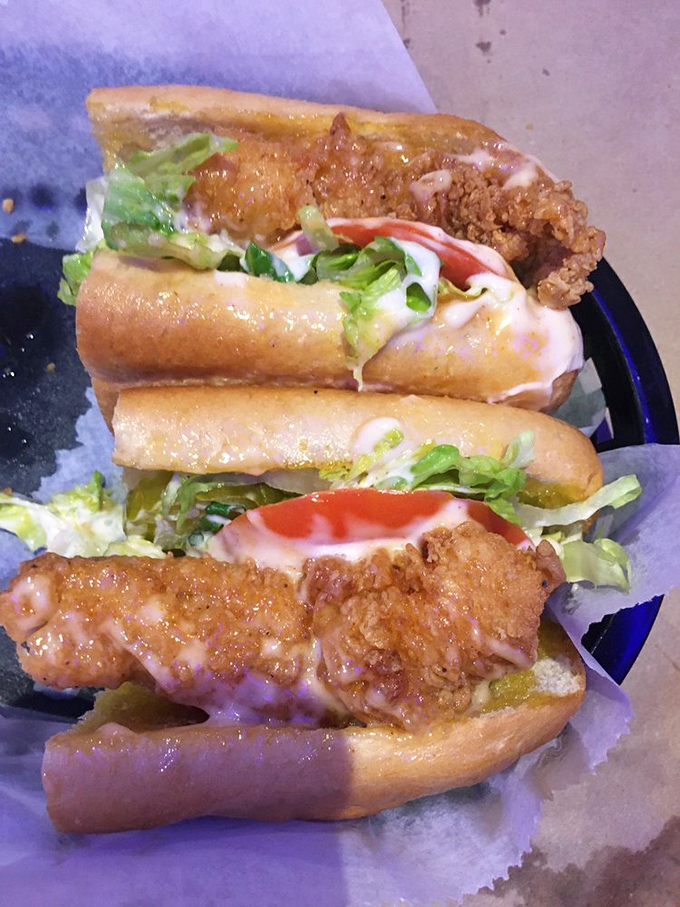The po' boy sandwich: where crispy fried seafood meets soft bread in a marriage so perfect it should have its own reality show. Lettuce and sauce add the drama.