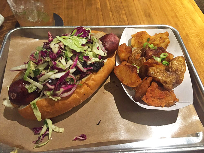 The Polish Girl sandwich stands tall and proud, a glorious mess of sausage and slaw that requires both hands, several napkins, and absolutely zero shame.