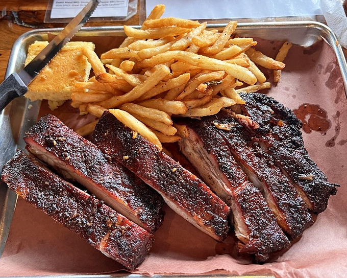 Ribs with the perfect bark-to-bite ratio. That glistening exterior promises a flavor explosion that makes you understand why humans invented napkins and wet wipes.