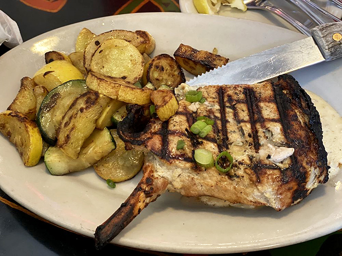 A pork chop that's achieved grill mark perfection, flanked by vegetables that didn't just show up &ndash; they came to play.