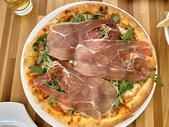 Pizza that honors its ingredients: perfectly blistered crust, paper-thin prosciutto, and peppery arugula. Simple food made extraordinary through quality and care. 