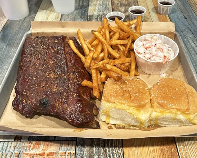 A tray of ribs, fries, slaw, and those pillowy rolls &ndash; this isn't just lunch, it's a commitment to excellence and possibly an afternoon nap.
