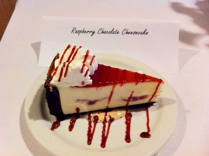 Raspberry chocolate cheesecake drizzled with sauce because sometimes regular cheesecake just isn't fancy enough for a Tuesday lunch celebration.