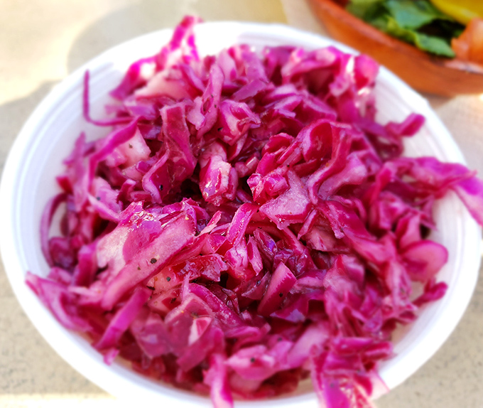 Not all slaws are created equal. This vibrant red cabbage version adds a zingy crunch that cuts through rich barbecue like a well-timed punchline.
