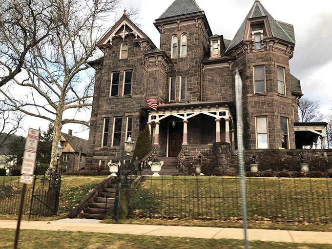The Reynolds Mansion stands like a gothic novel come to life, its dark stone facade and intricate details hinting at stories waiting to be discovered.