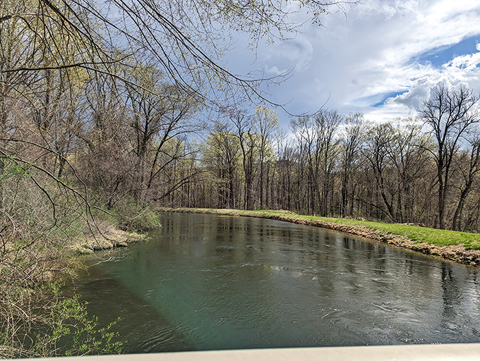 The Housatonic River flows peacefully past the bridge, its clear waters inviting contemplation and the occasional ambitious trout fisherman.