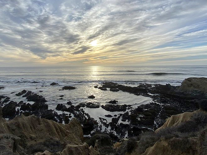 Sunset casts its golden spell over tide pools and rocky outcroppings, turning an ordinary evening into a moment of pure California magic.