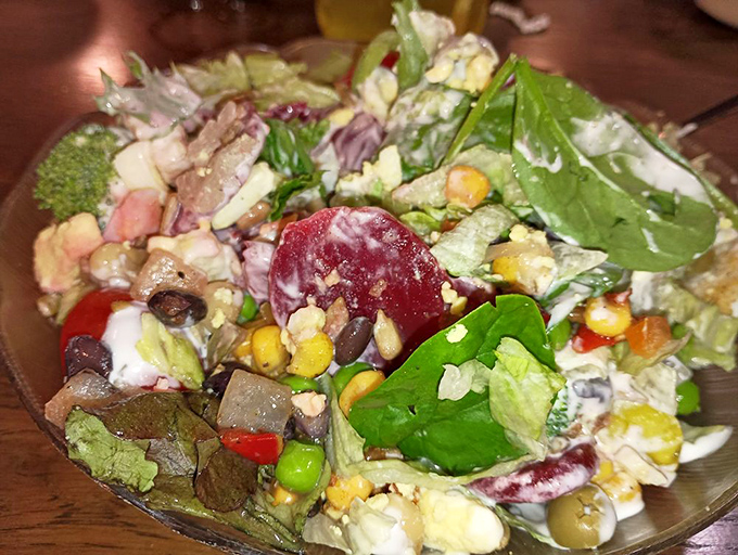 The salad that defies the "rabbit food" stereotype. This colorful masterpiece packs more ingredients than some restaurants have on their entire menu.