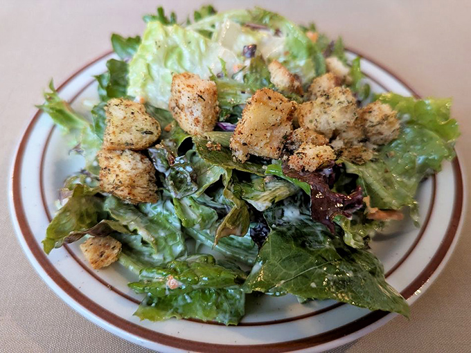 Even the salad gets the star treatment here, with crisp greens and seasoned croutons playing more than just a token healthy role.