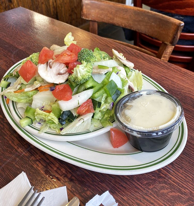 The health salad offers a moment of virtuous eating before returning to the sandwich that's waiting patiently for your attention.