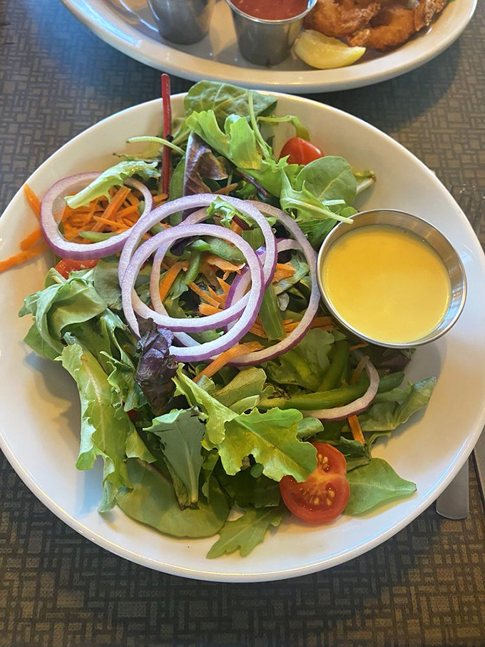 A fresh garden salad that somehow doesn't feel like punishment when surrounded by seafood – balance is everything!